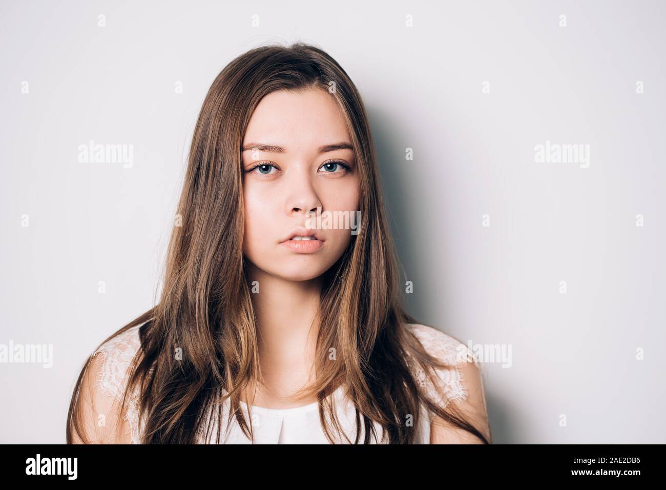 young beautiful sad woman serious and concerned looking worried and ...