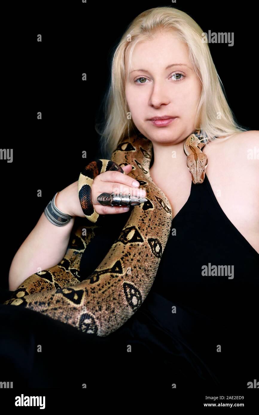 Portrait of girl with Boa constrictor snake. Beautiful woman holds ...