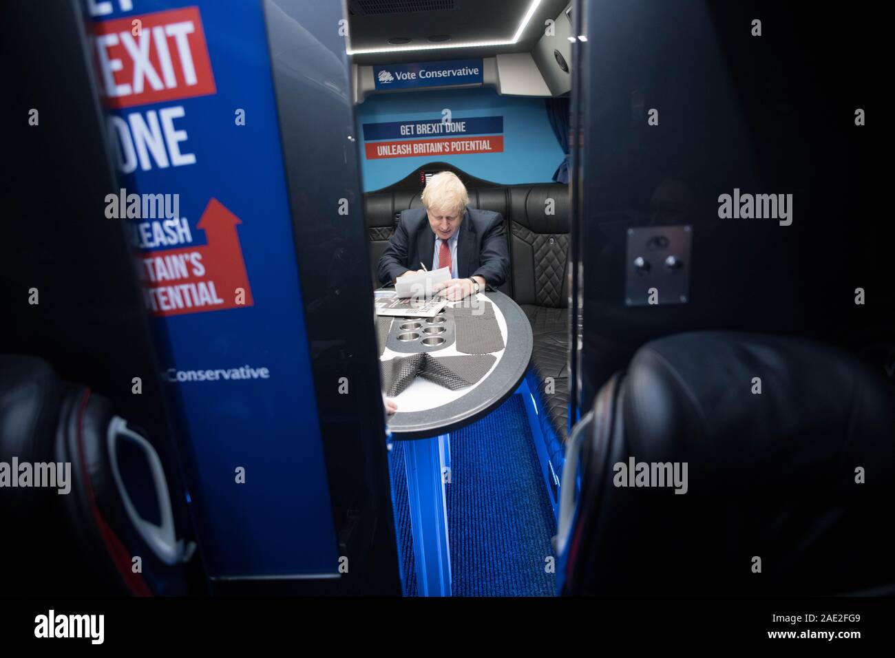 Prime Minister Boris Johnson, works in his campaign bus as he heads to ...