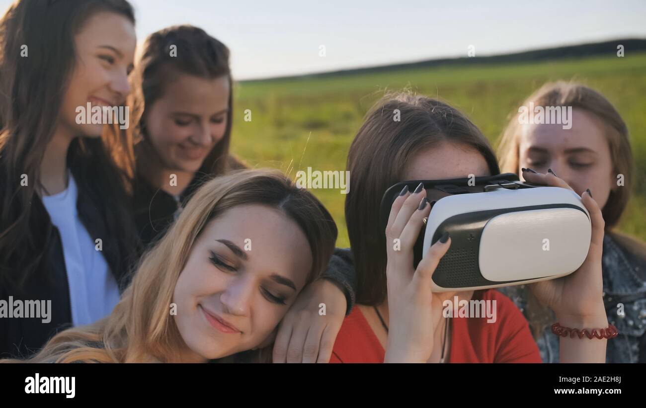 Fun school friends alternately wear virtual glasses Stock Photo - Alamy