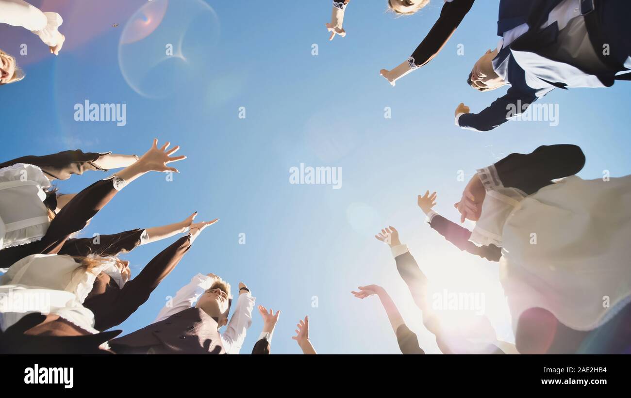 Happy friends students join hands together. The concept of a friendly ...