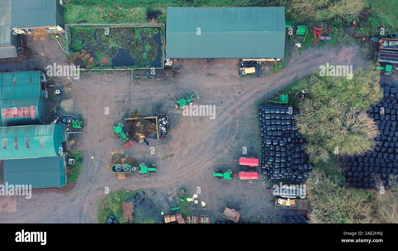 Aerial bireds eye view of a working farm yard with tractors and ...