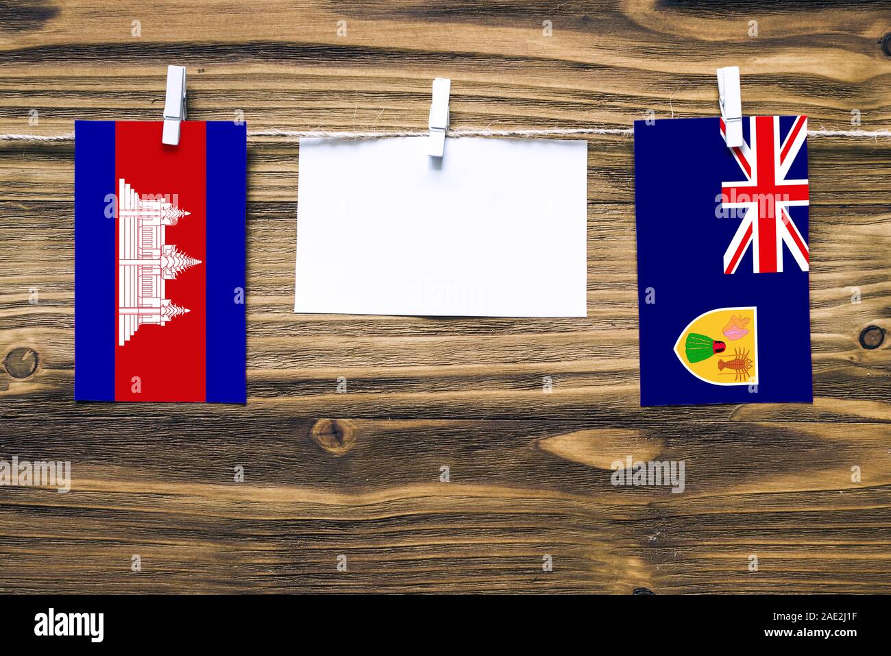Hanging flags of Cambodia and Turks And Caicos Islands attached to rope ...