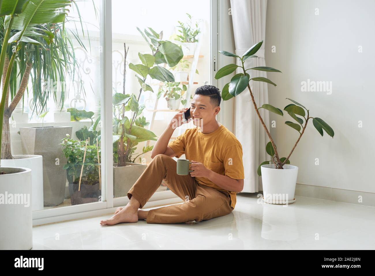 Korean smiling guy looking phone hi-res stock photography and images ...