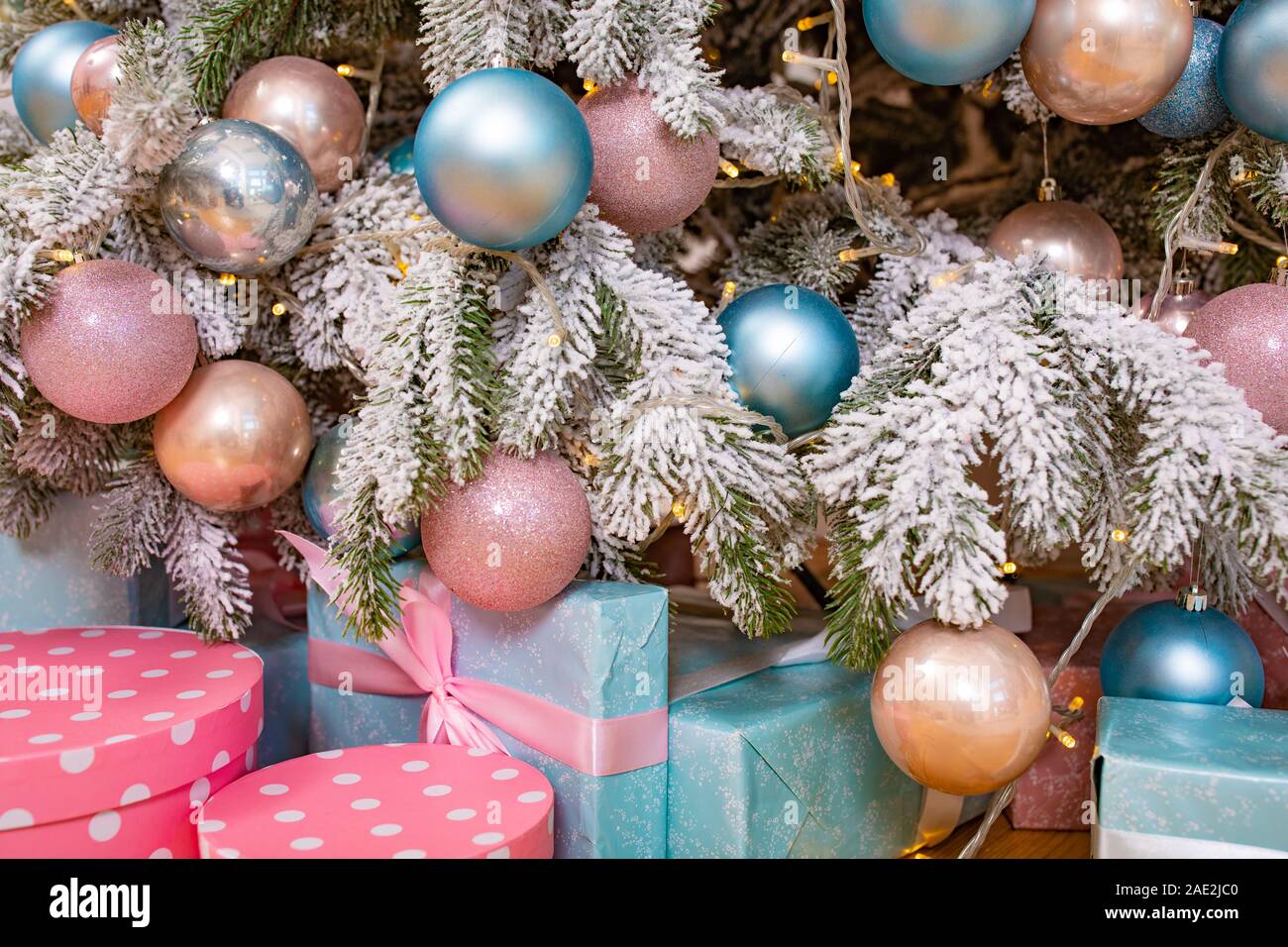 Beautiful gift boxes under Christmas tree in the room, close up Stock ...