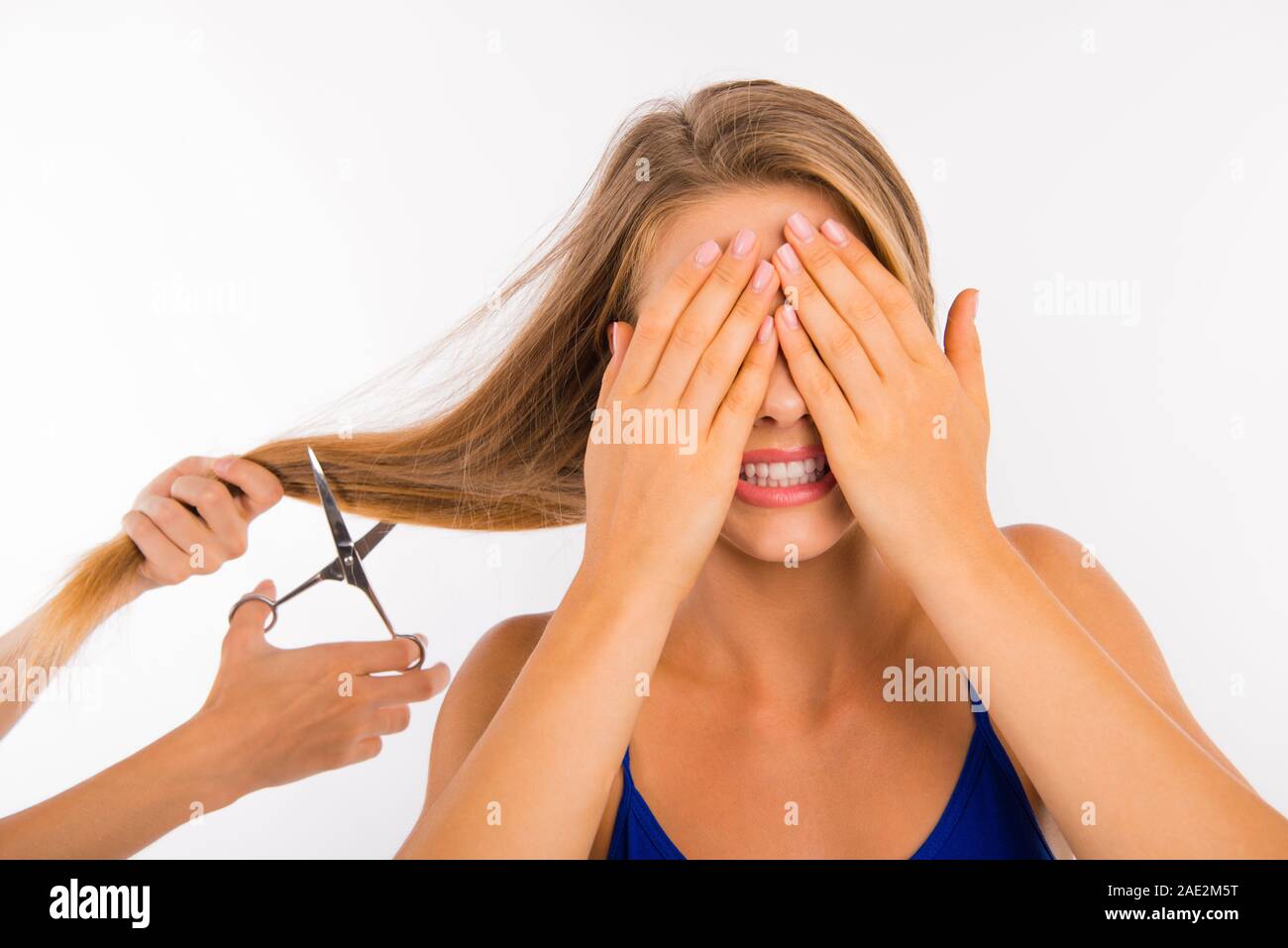 Scared disappointed woman going to cut her split ends Stock Photo - Alamy
