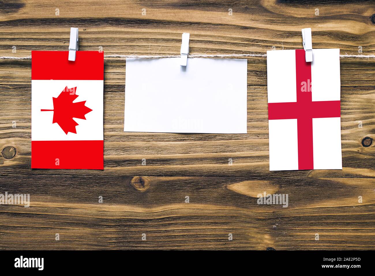 Hanging flags of Canada and England attached to rope with clothes pins ...
