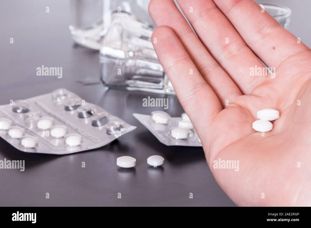Pills and alcohol on a grey table. Concept for drug abuse Stock Photo ...