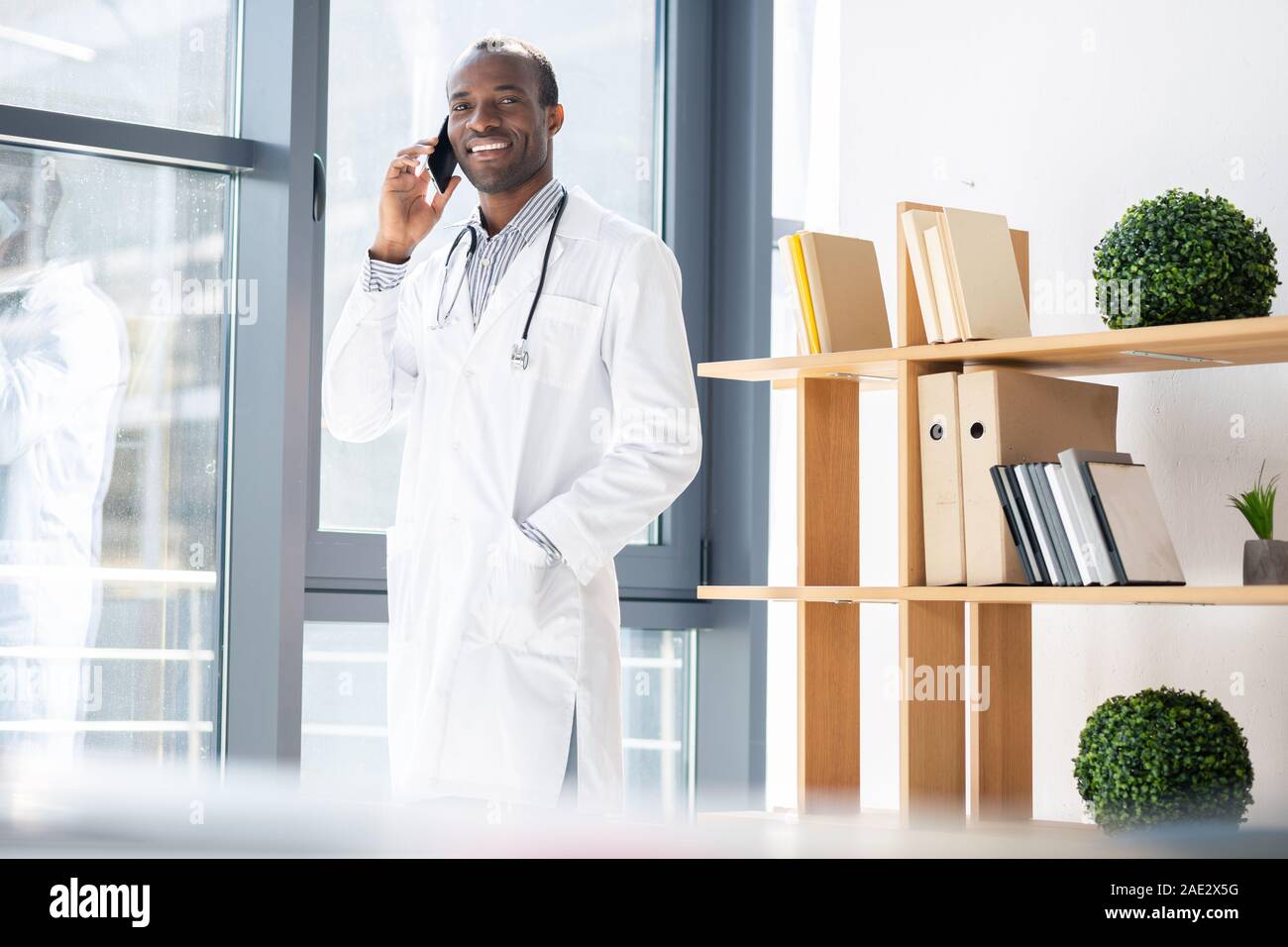 Handsome international practitioner posing on camera Stock Photo - Alamy