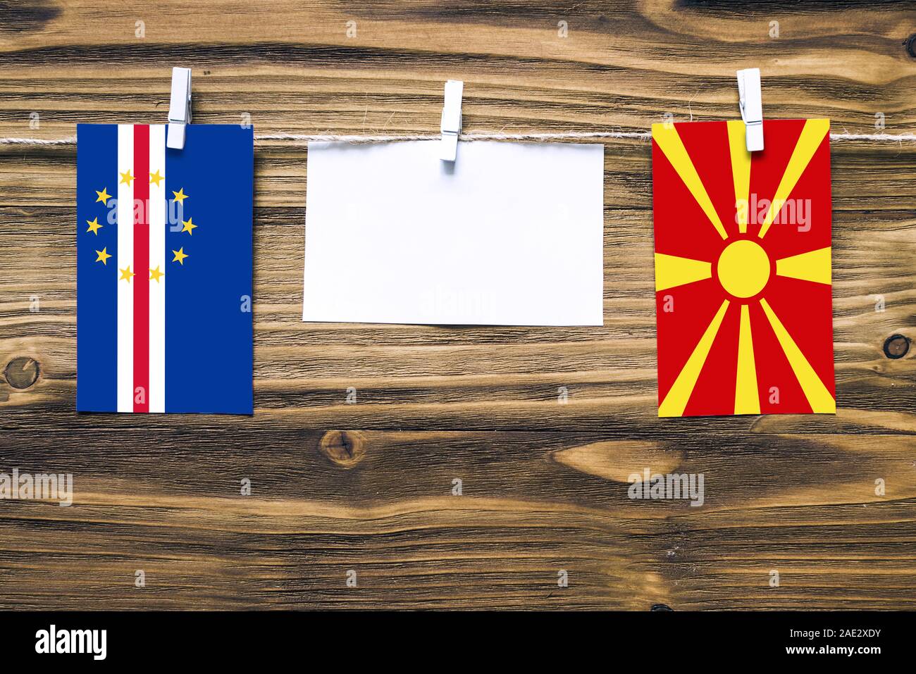 Hanging flags of Cape Verde and Macedonia attached to rope with clothes ...