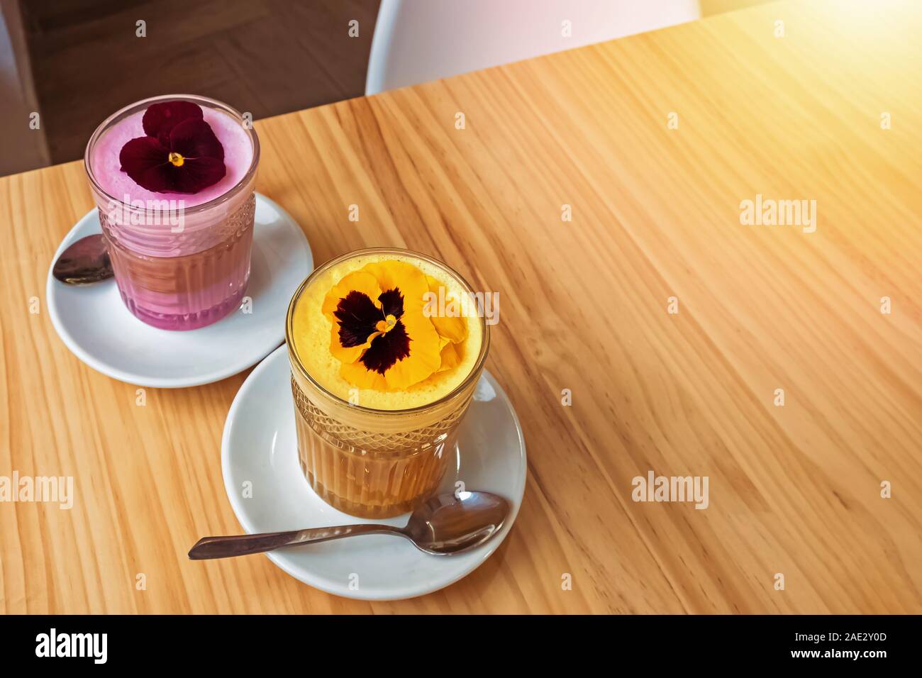 Pink and yellow colorful latte drink decorated with flowers Stock Photo ...