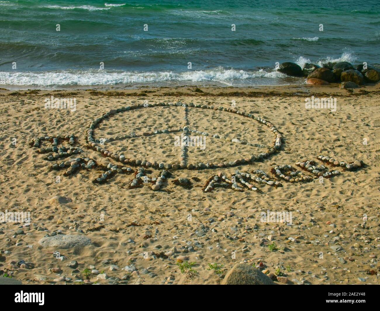 Symbol Earth Angel layed out with pebbles on the beach of the North ...