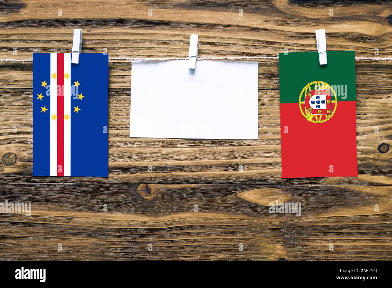 Hanging flags of Cape Verde and Portugal attached to rope with clothes ...