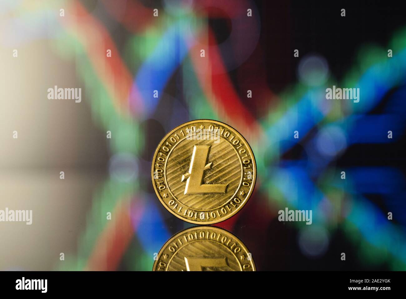 Litecoin and virtual money concept. Gold bitcoins with chart of growing ...