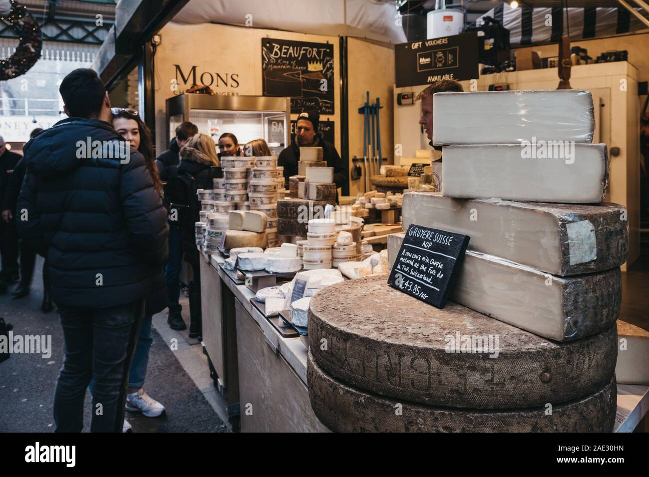 London, UK - November 29, 2019: Wheels of cheese on sale at a stand ...