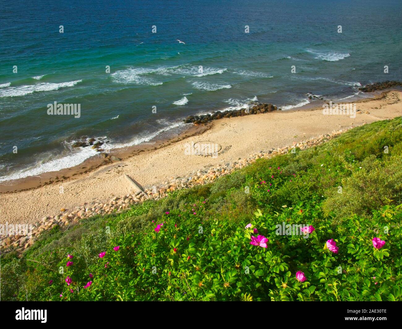 Symbol Earth Angel layed out with pebbles on the beach of the North ...