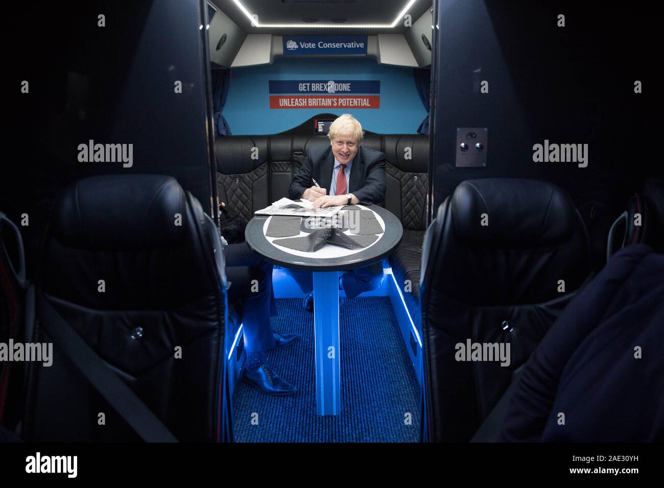 Prime Minister Boris Johnson, works in his campaign bus as he heads to ...
