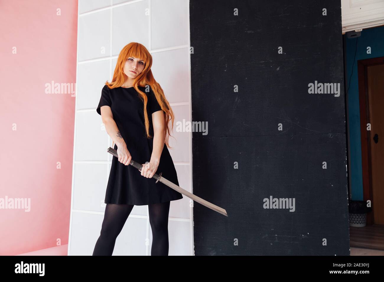 beautiful woman anime cosplayer with red hair with Japanese sword Stock ...