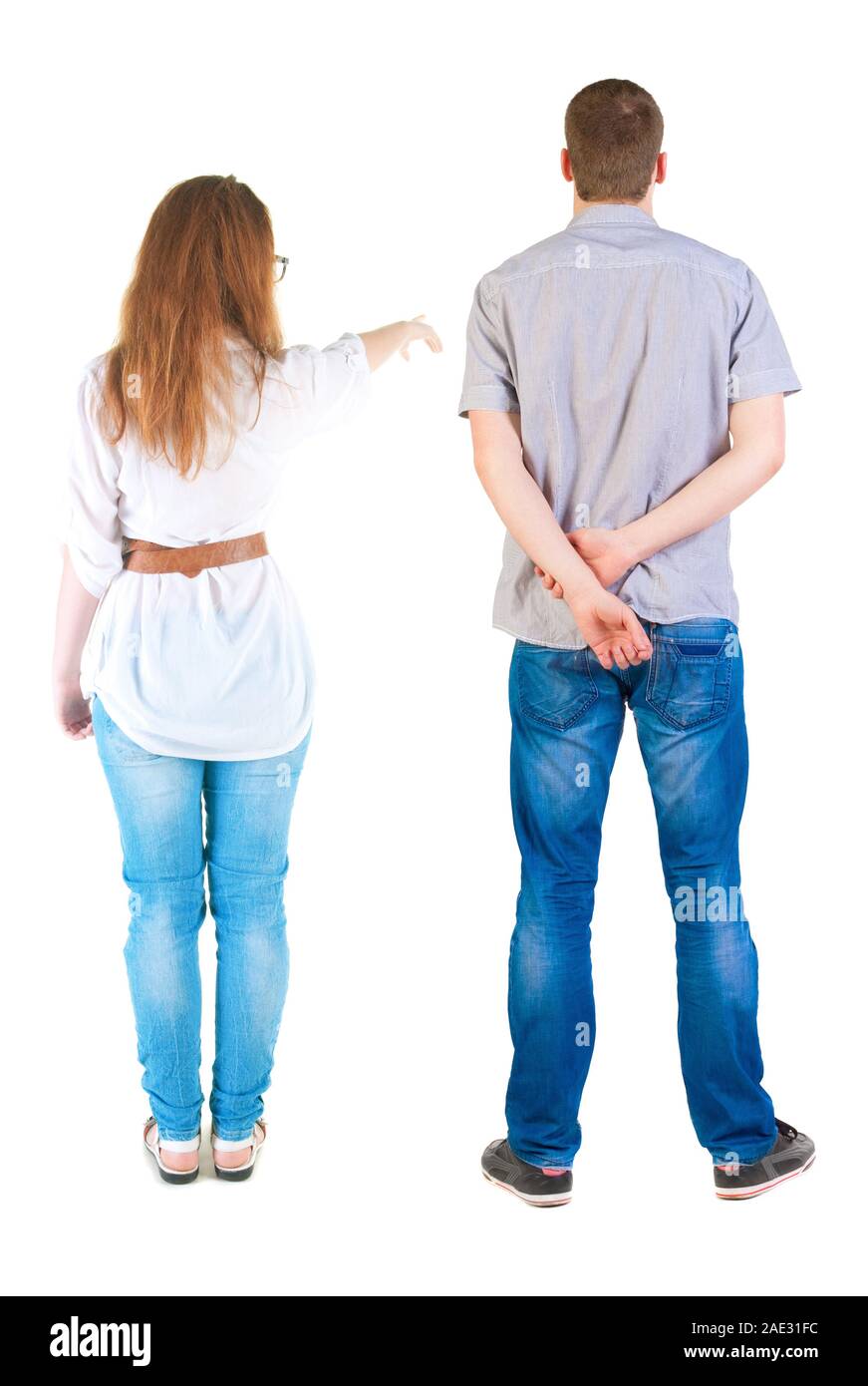 Back view of a stylish couple pointing. beautiful friendly girl and guy ...