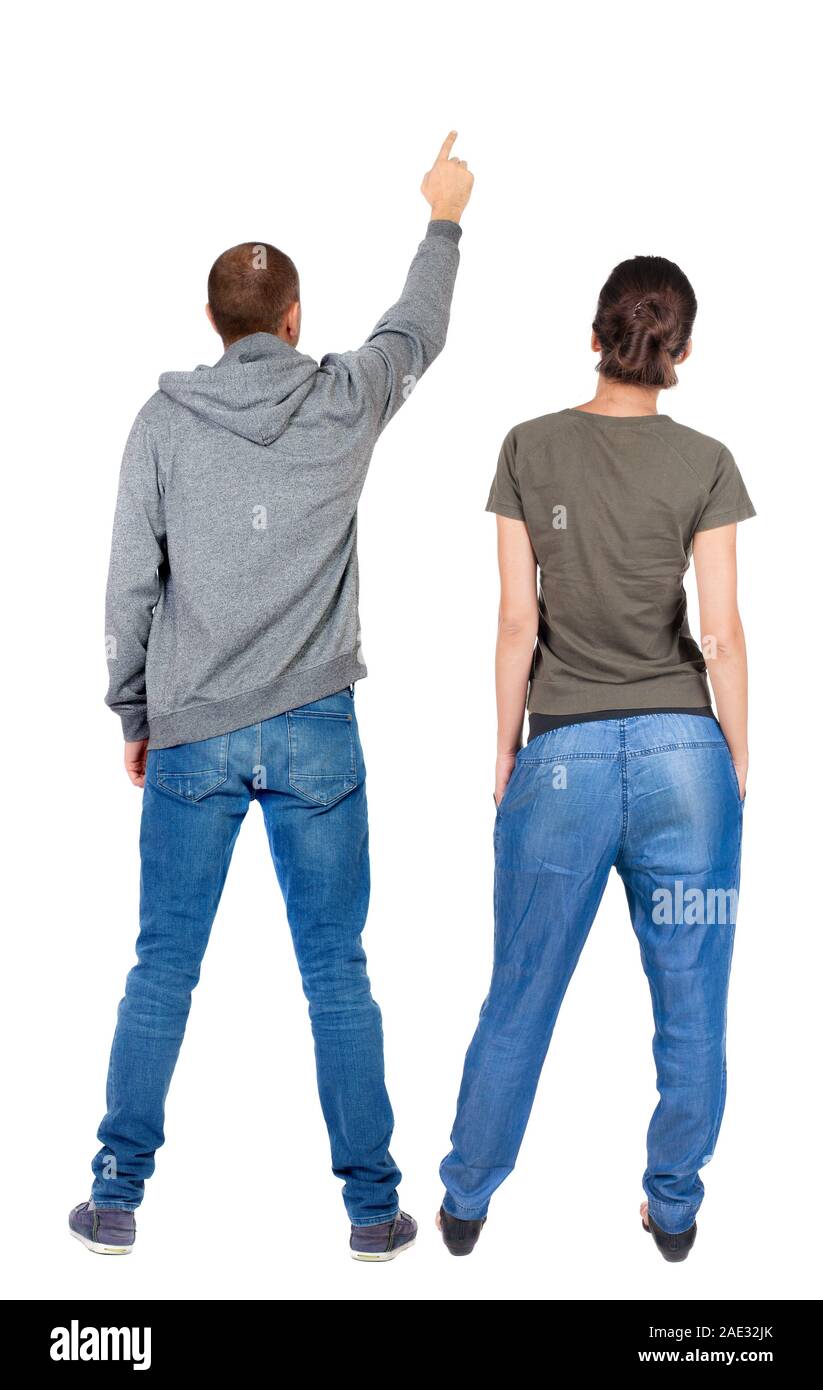 Back view of a stylish couple pointing. beautiful friendly girl and guy ...