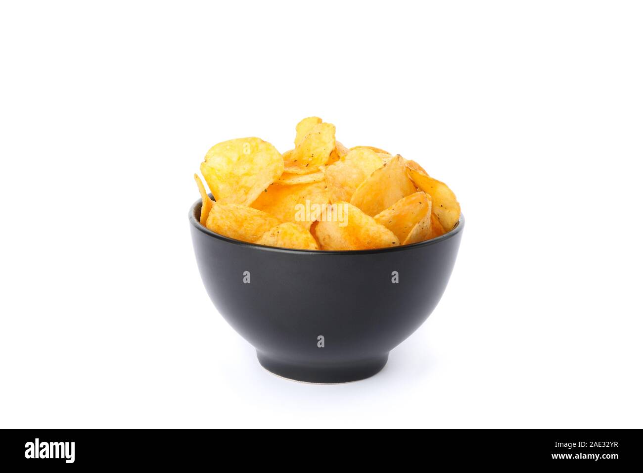 Potato chips in a black bowl isolated on white background, space for ...