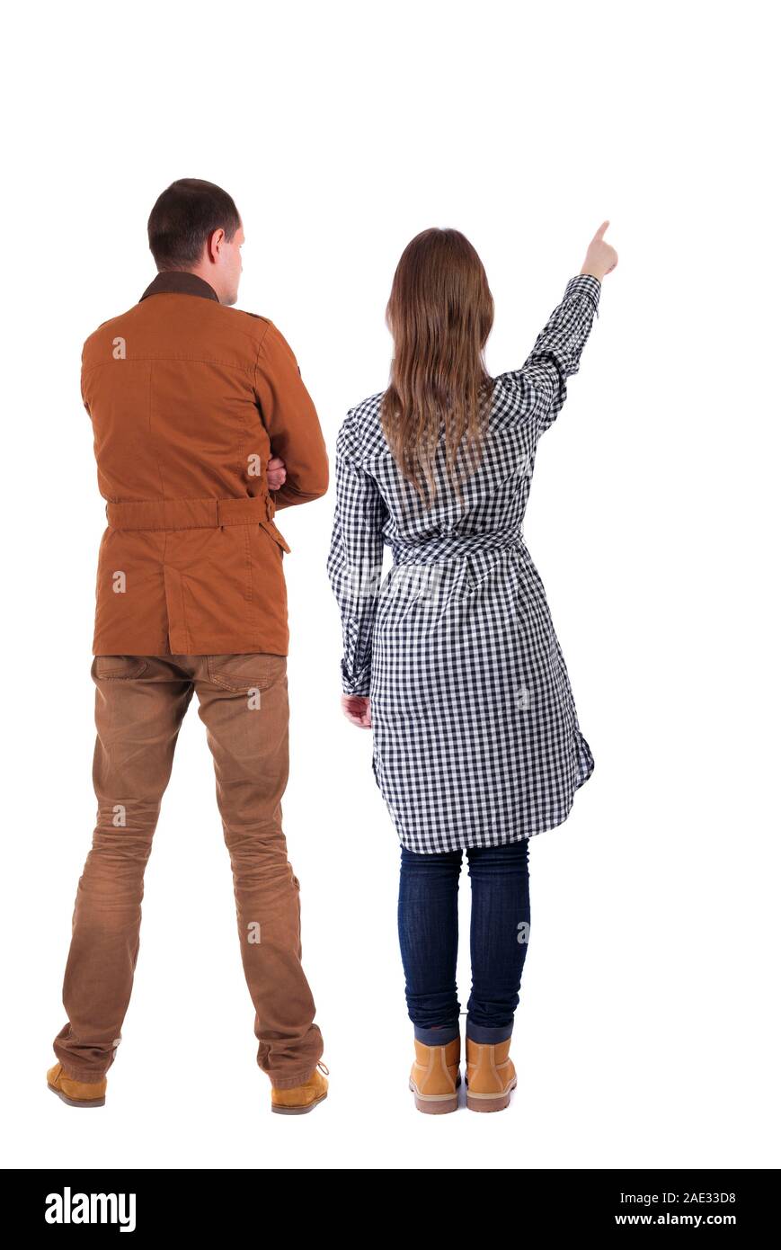 Back view of a stylish couple pointing. beautiful friendly girl and guy ...