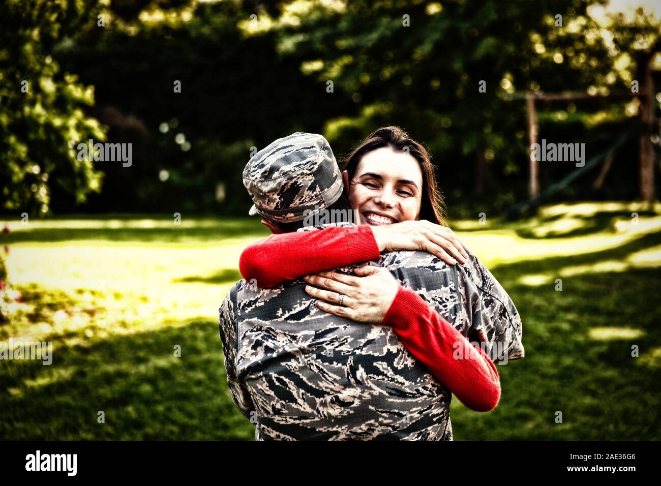 Soldier embracing female partner Stock Photo - Alamy