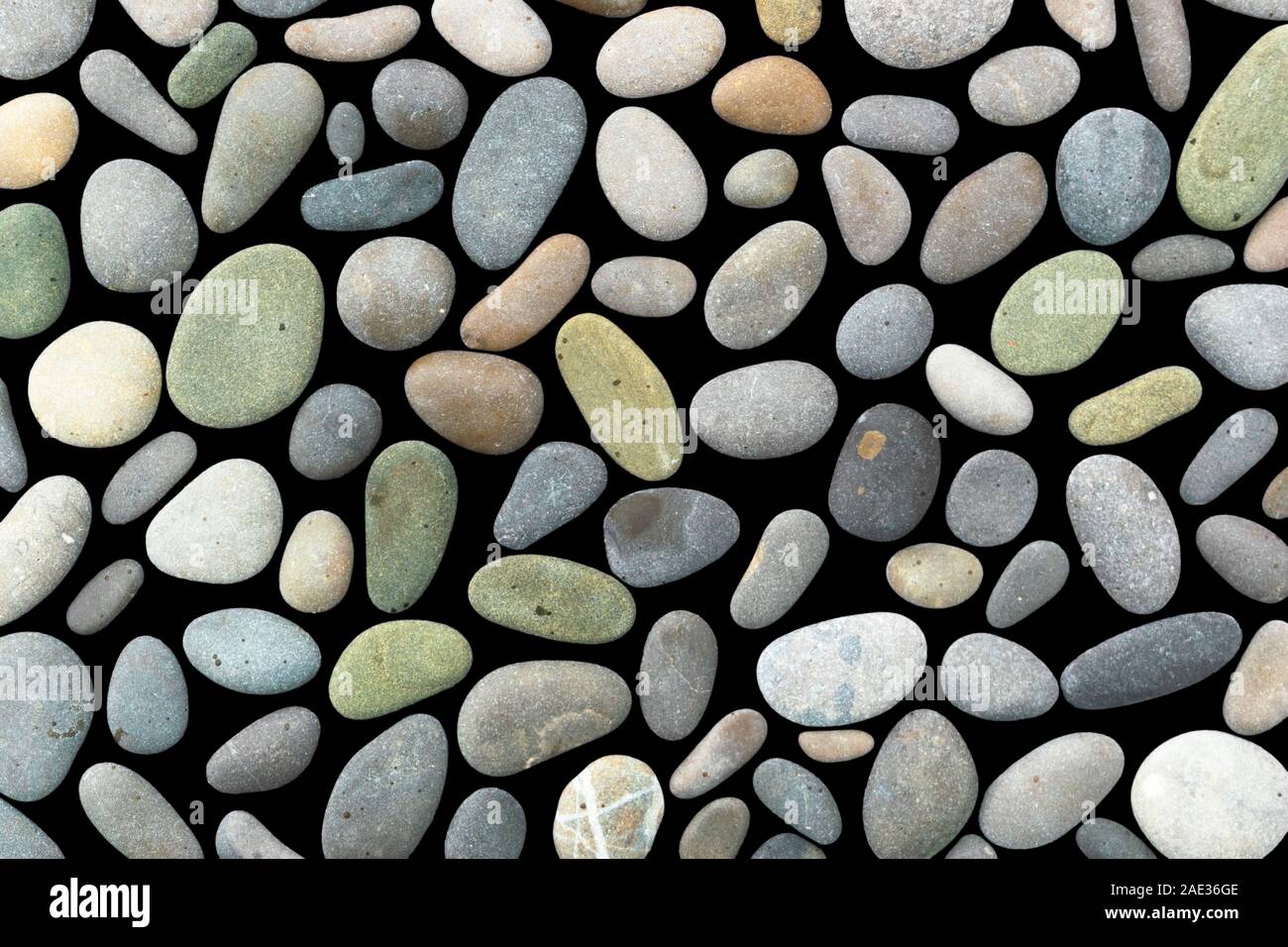 Different colorfull small sea stones isolated on black background ...