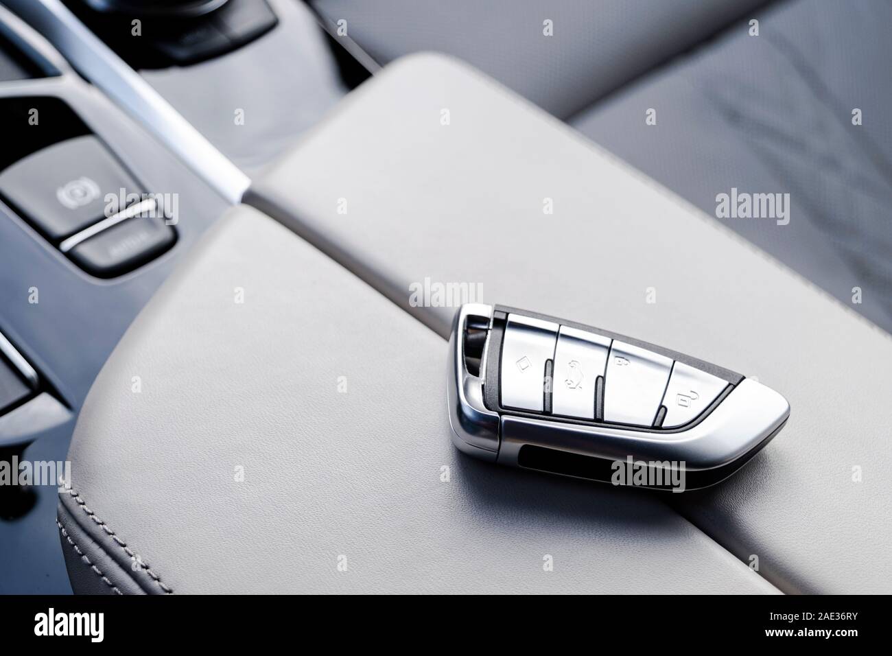 Closeup inside vehicle of wireless key ignition on white perforated ...