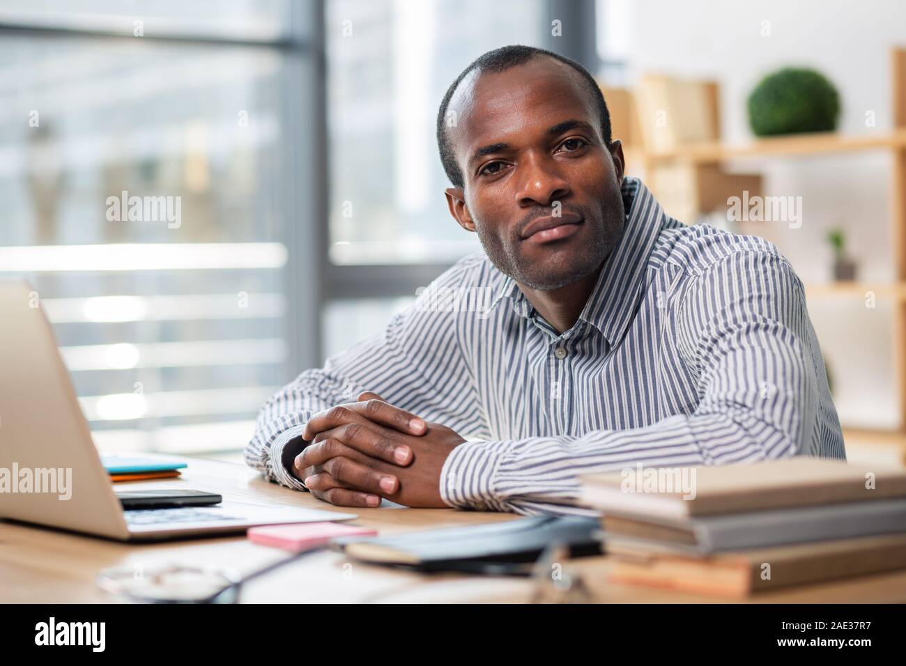 Concentrated dark-skinned man being at work Stock Photo - Alamy