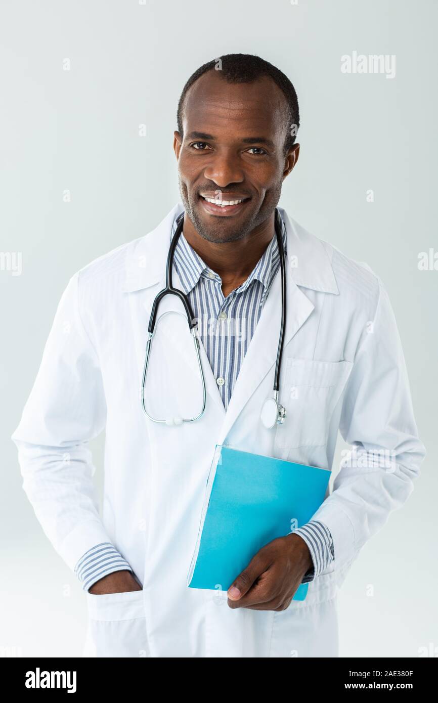 Delighted professional doctor holding a medical history Stock Photo - Alamy