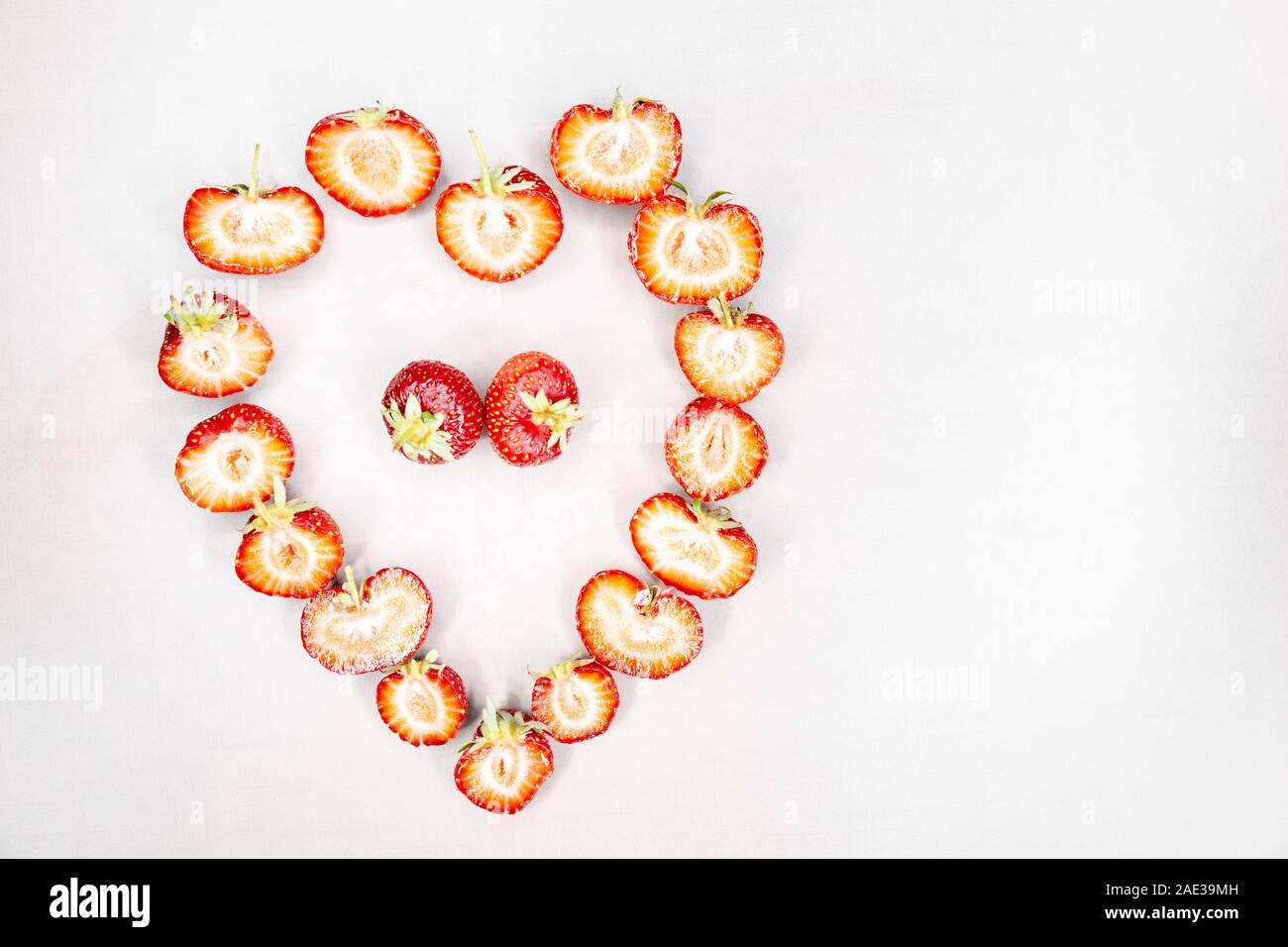 A half-cut strawberry almost seems to form a heart. And many ...