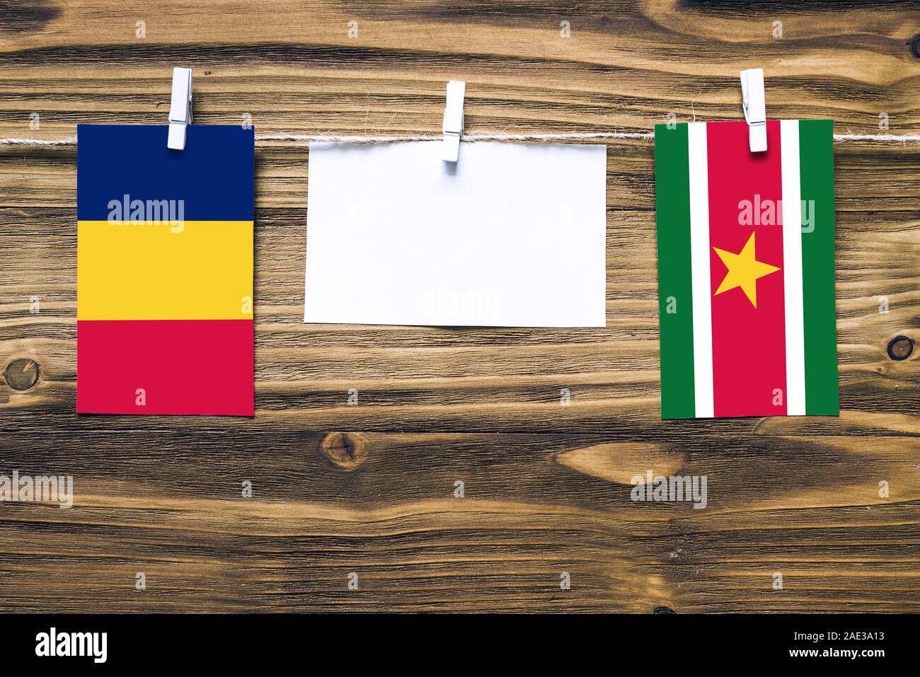 Hanging flags of Chad and Suriname attached to rope with clothes pins ...