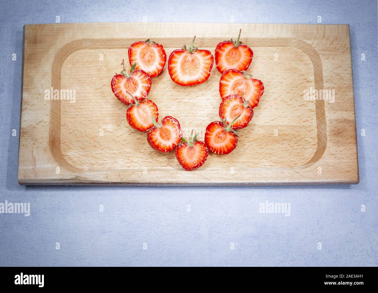 Strawberries cut in half to simulate a heart, joined together to form ...