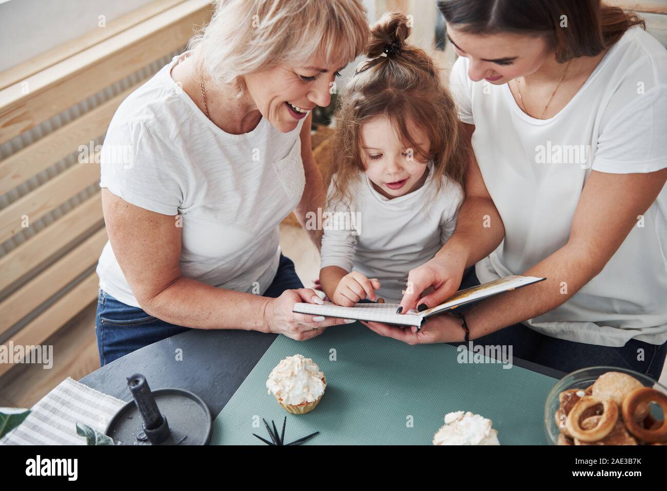 Tell us what is that word. Mother, grandmother and daughter having good ...