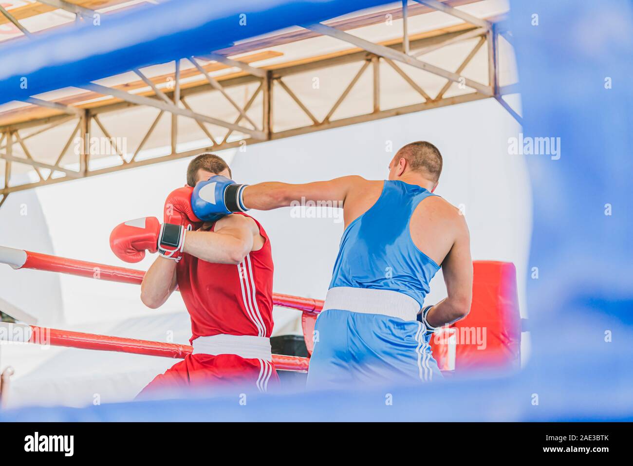 Two boxers fighting in the boxing ring. Boxer lead for the opposition ...