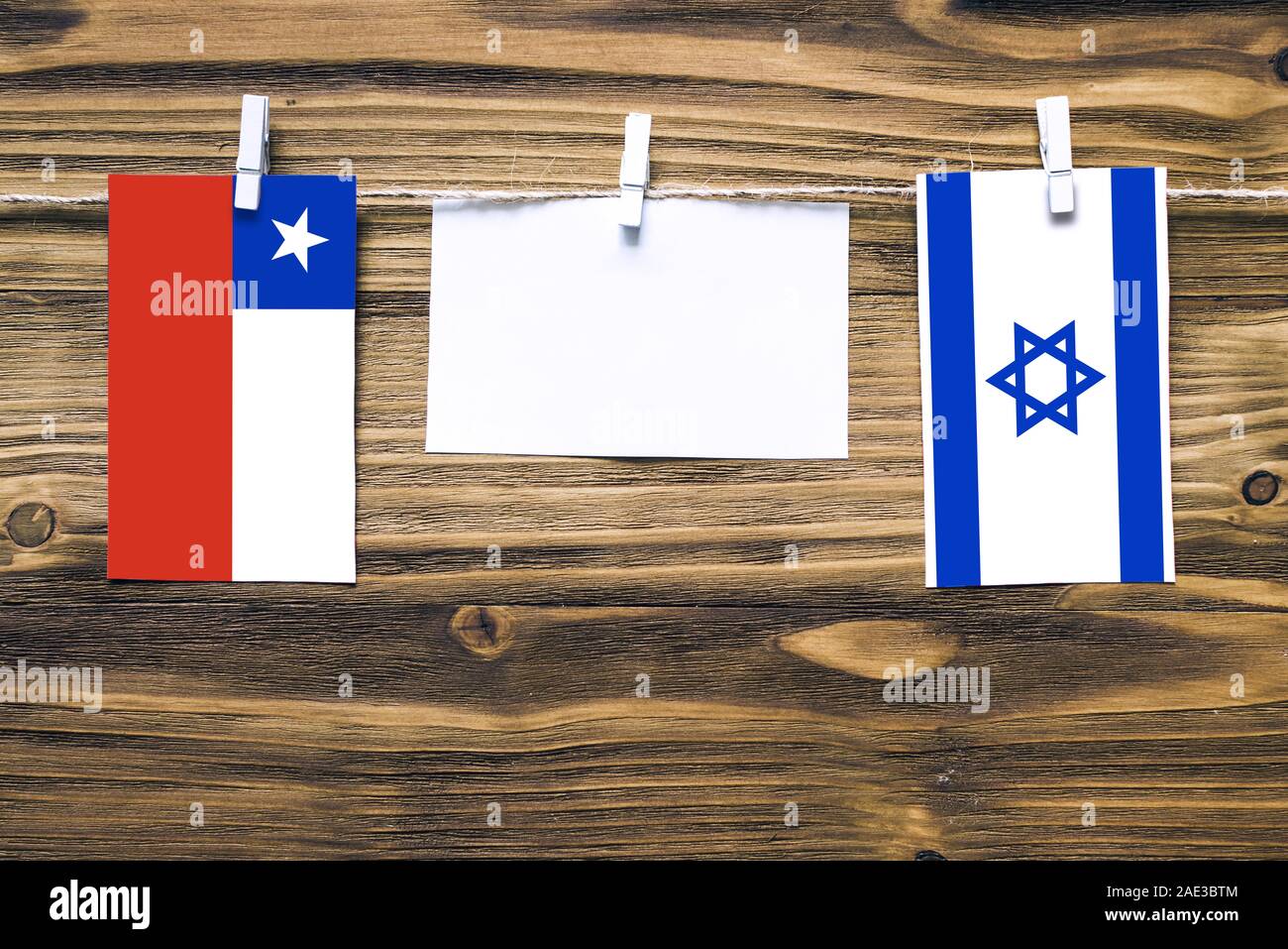 Hanging flags of Chile and Israel attached to rope with clothes pins ...