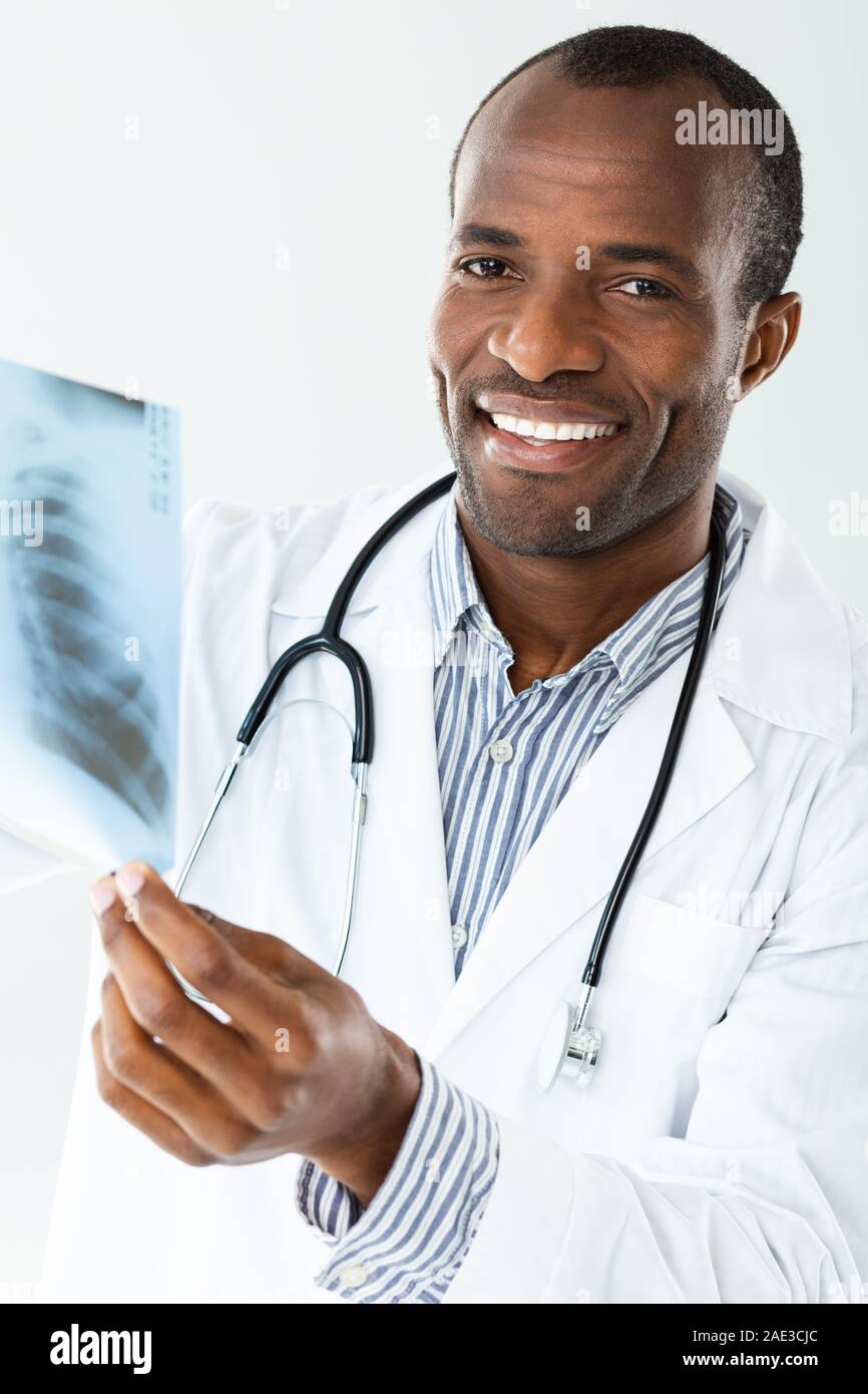 Cheerful experienced doctor holding x-ray scan Stock Photo - Alamy