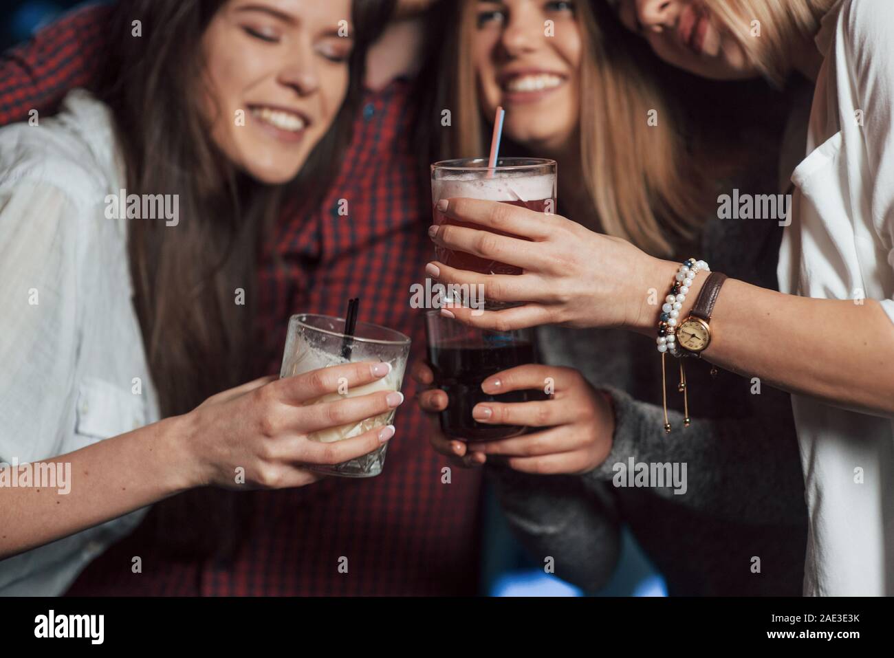 Different types of cocktails. Group of young friends smiling and making ...
