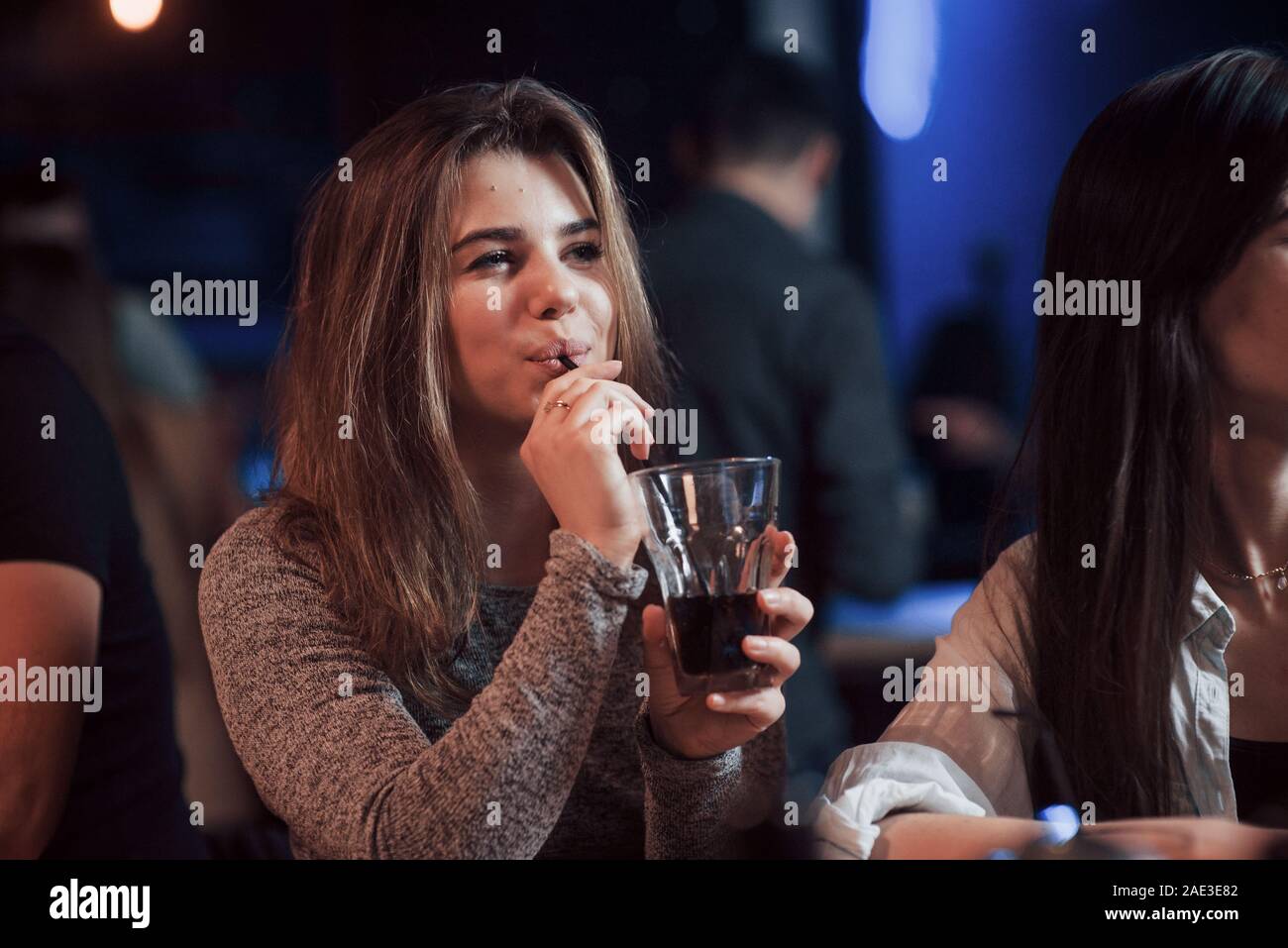 Drinking alcohol. Happy people have conversation in the luxury night ...