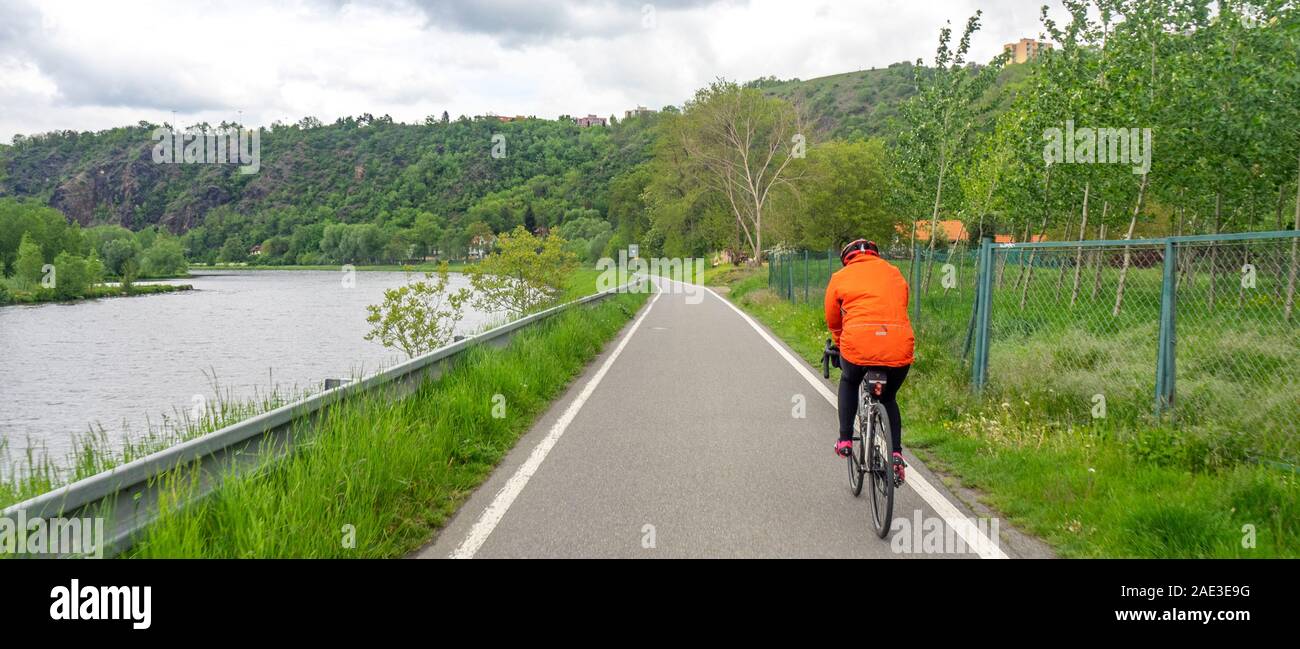 Woman traveler riding a bicycle on cycleway Vltava cycle route Eurovelo ...