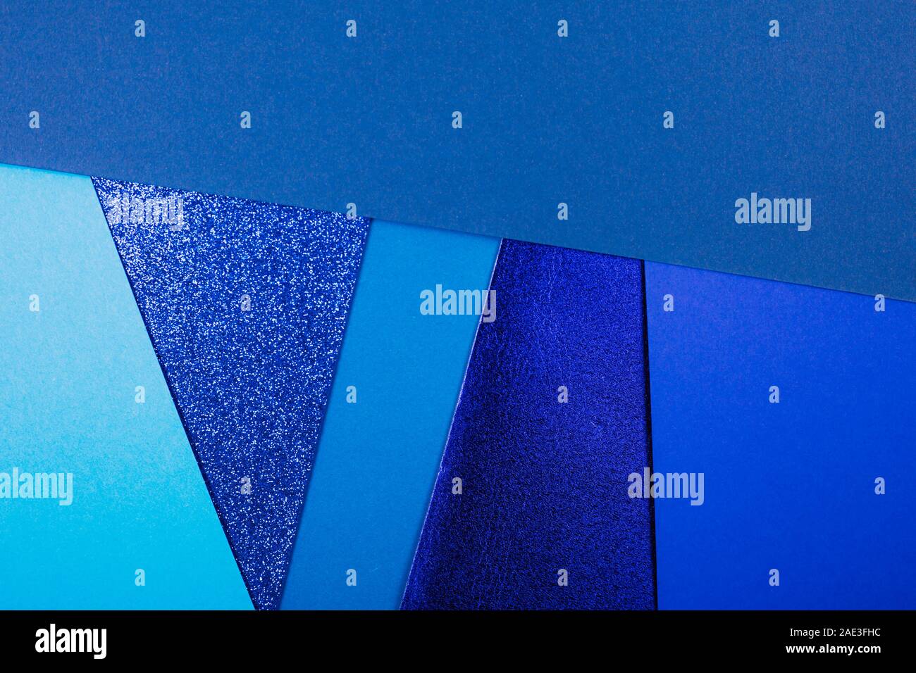 Divided in several parts blue paper background with metallic elemments ...