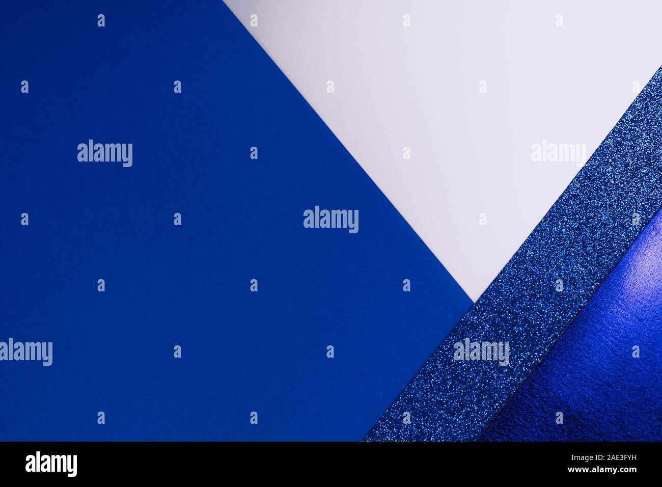 Divided in several parts blue paper background with metallic elemments ...