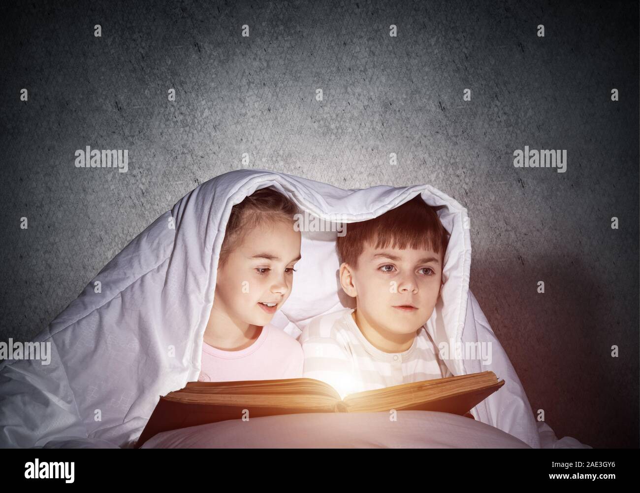 Happy children with flashlight hiding Stock Photo - Alamy