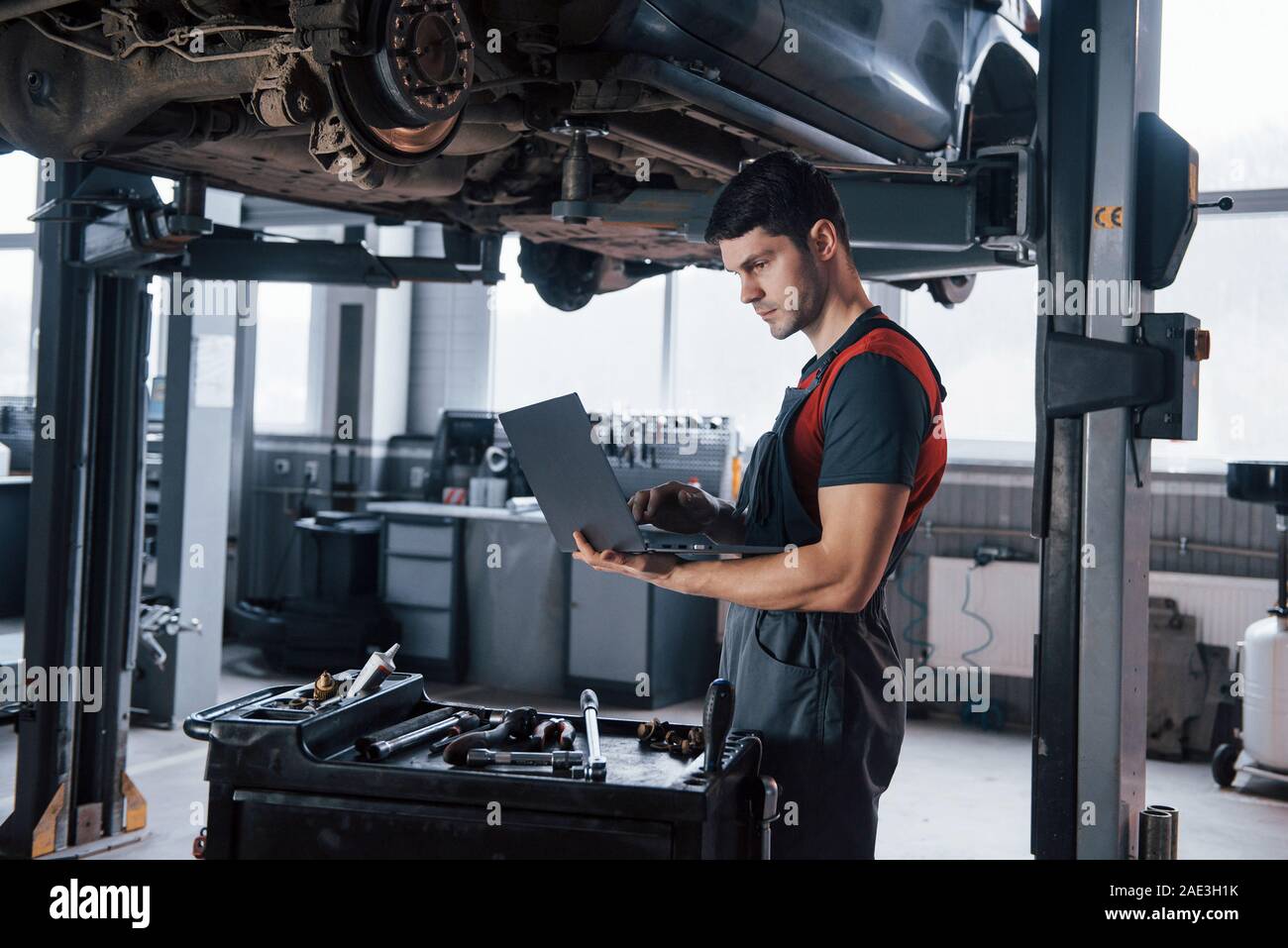 Car mechanic fixing a red car hi-res stock photography and images - Alamy