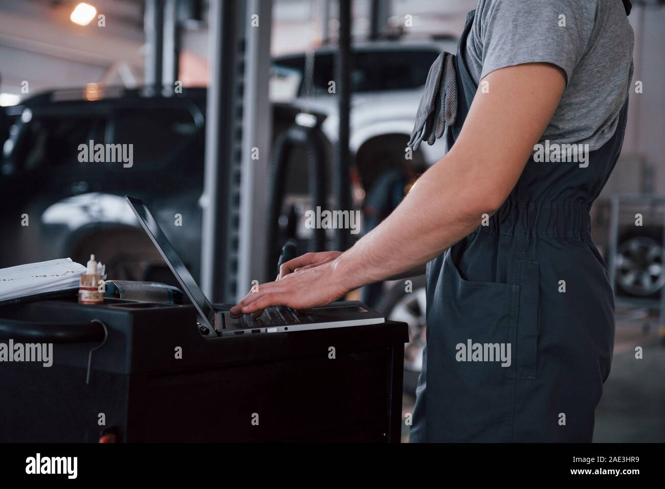 Browsing the internet. Worker stands indoors in uniform does reports ...