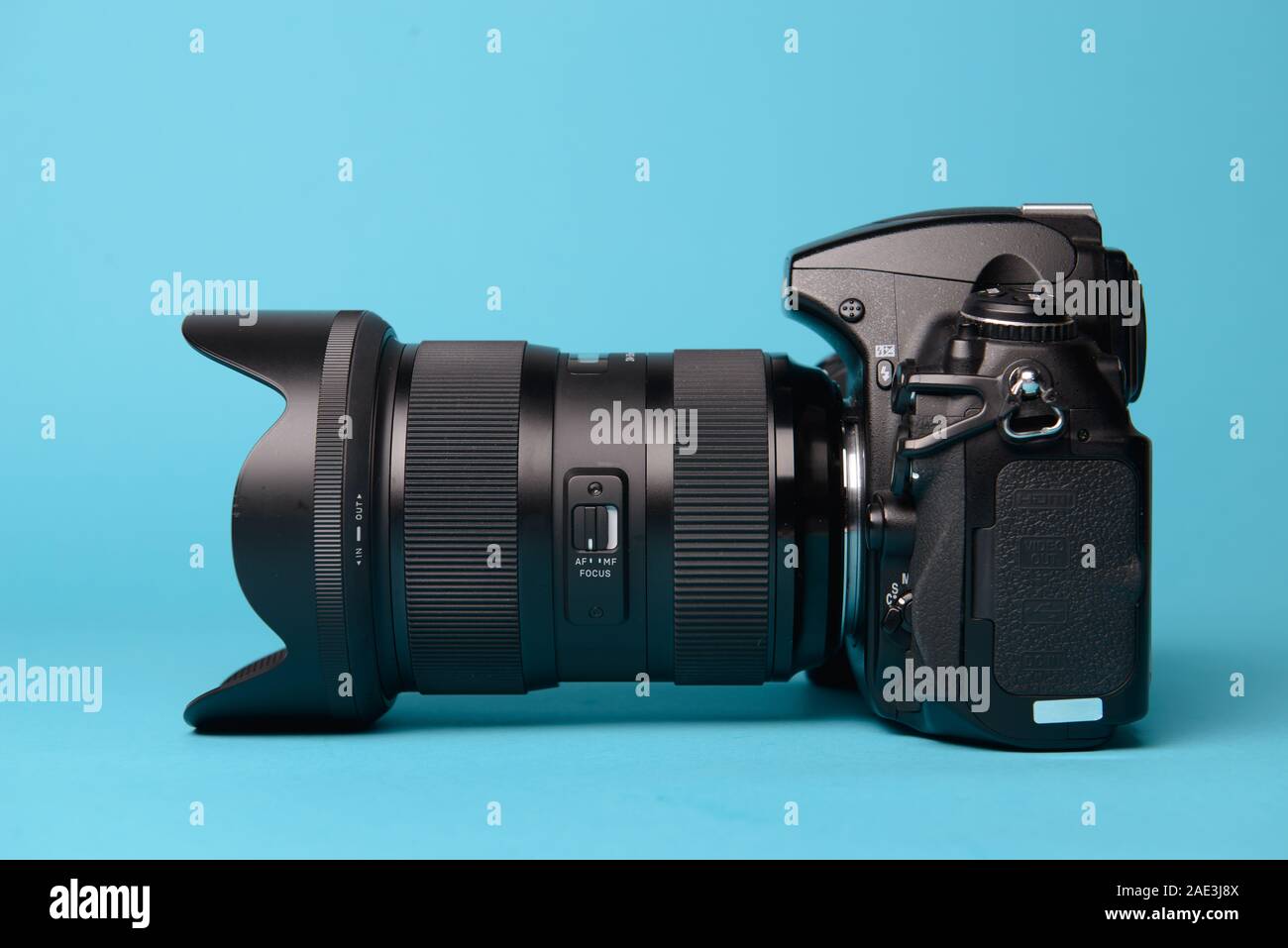 Professional modern DSLR camera against blue background Stock Photo - Alamy