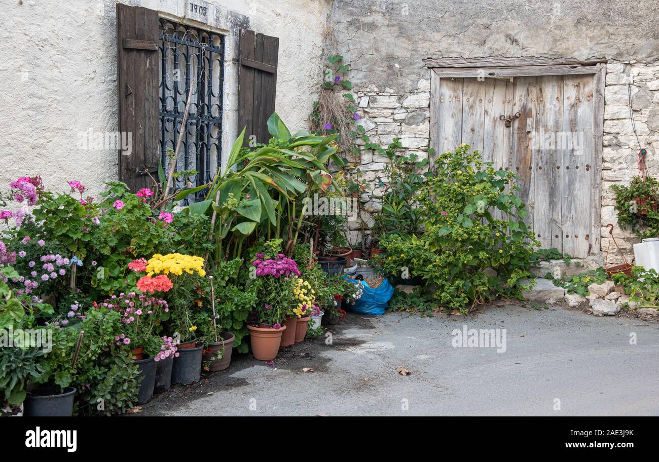 Traditional Cypriot house courtyard with wooden closed door and windows ...