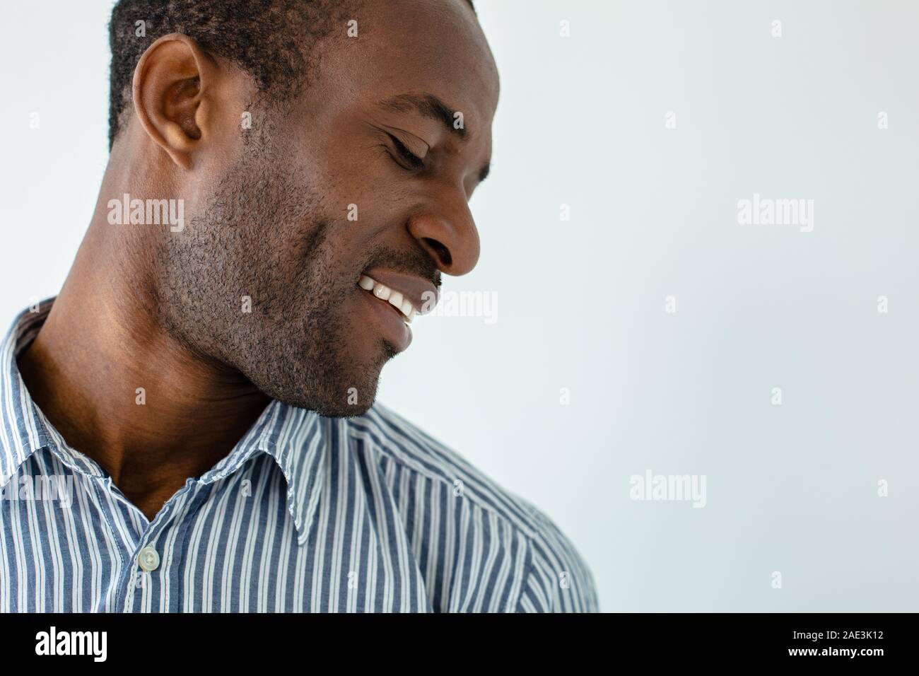 Joyful afro american man smiling on white background Stock Photo - Alamy