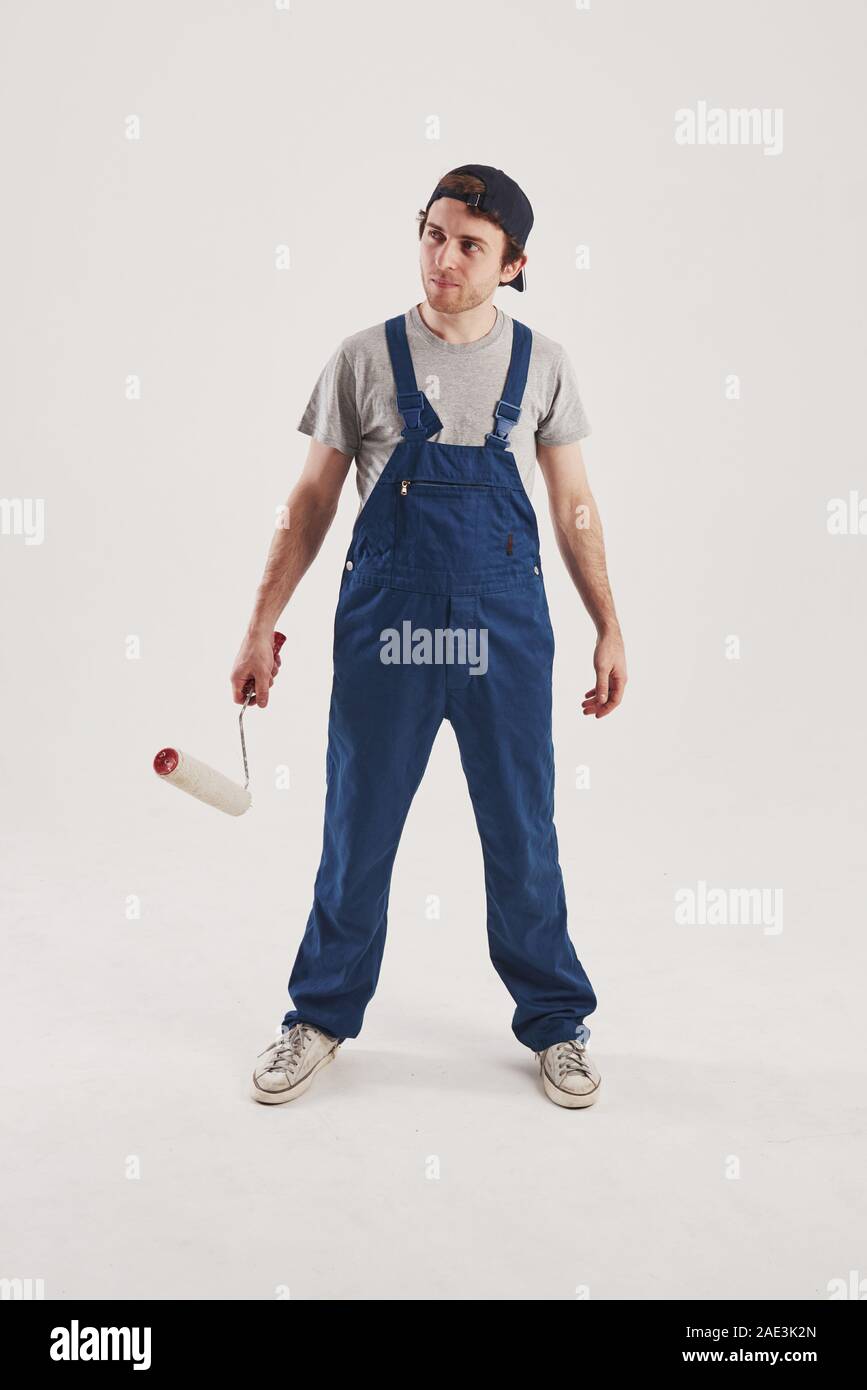 Full height photo. Man in blue uniform stands against white background ...